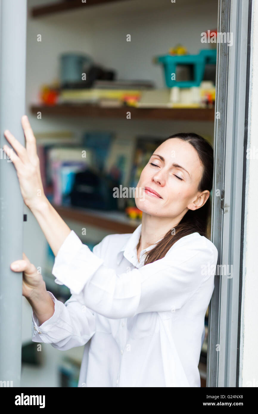Woman opening window Stock Photo - Alamy