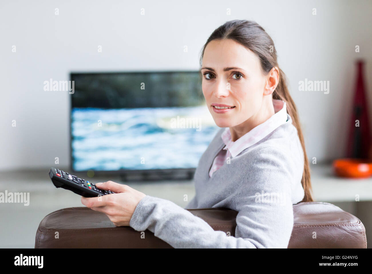 Woman watching TV Stock Photo - Alamy