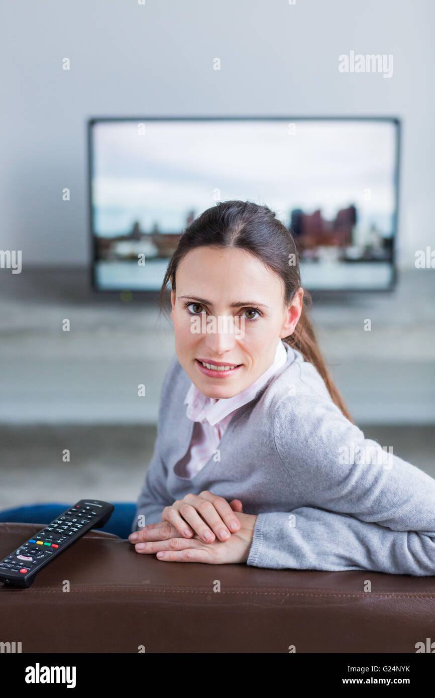 Woman watching TV Stock Photo - Alamy