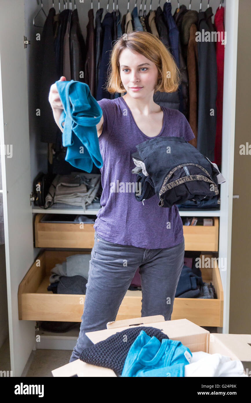 Woman throwing clothes in closet hi-res stock photography and images ...