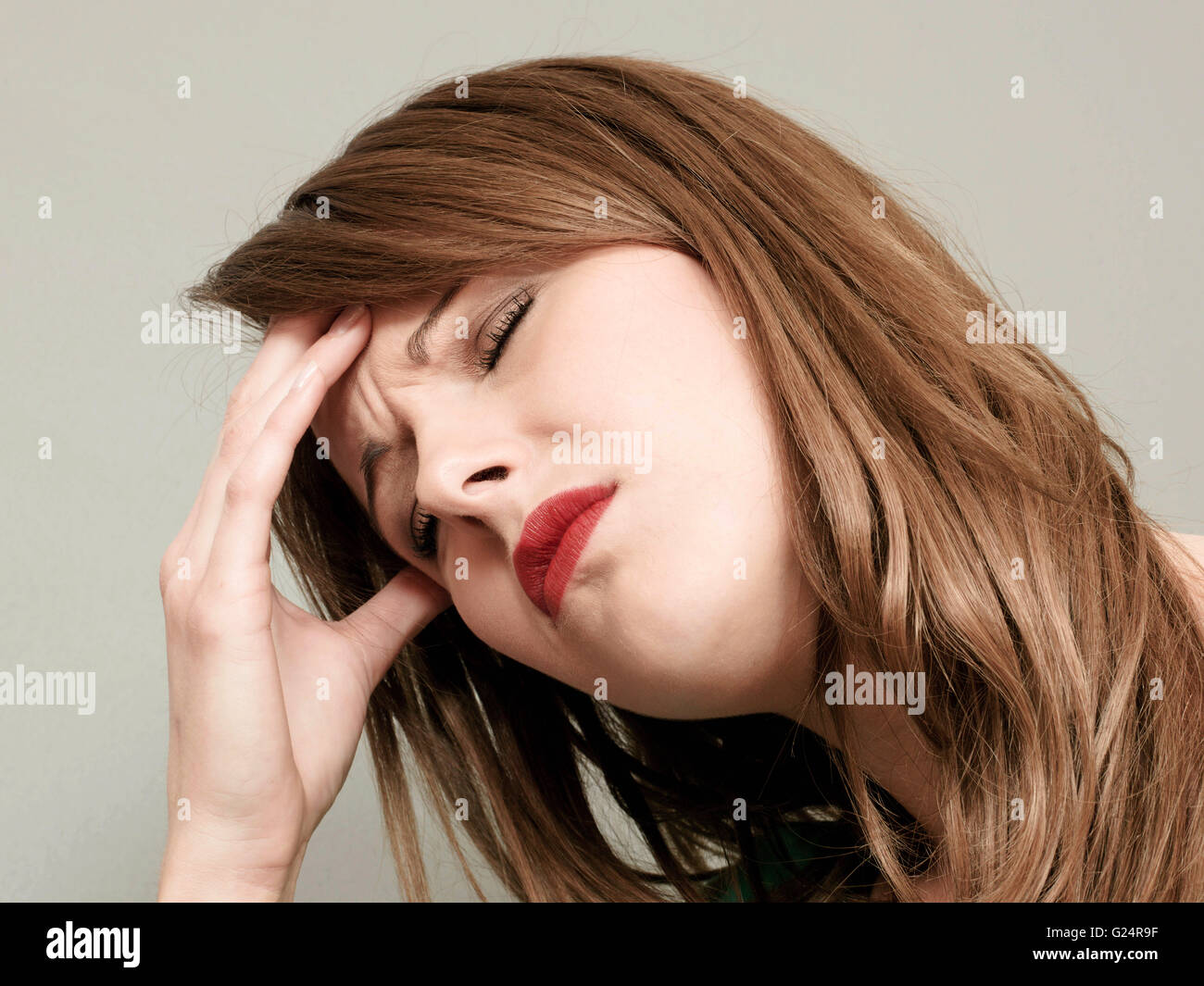 Portrait of a Woman Holding Her Forehead in Anguish Pain or Frustration ...
