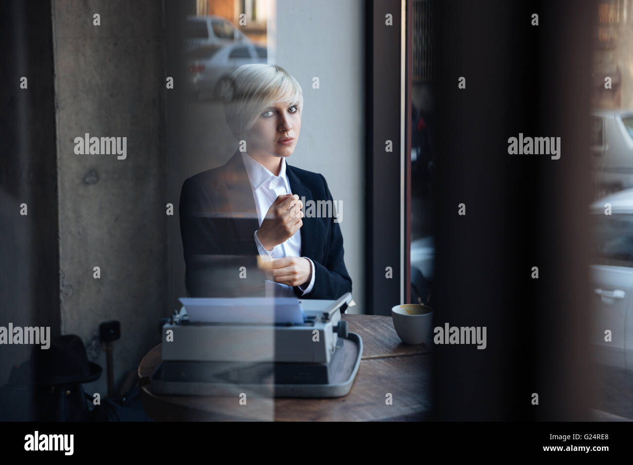 Stylish pretty blonde girl waiting for someone in a modern cafe,street ...