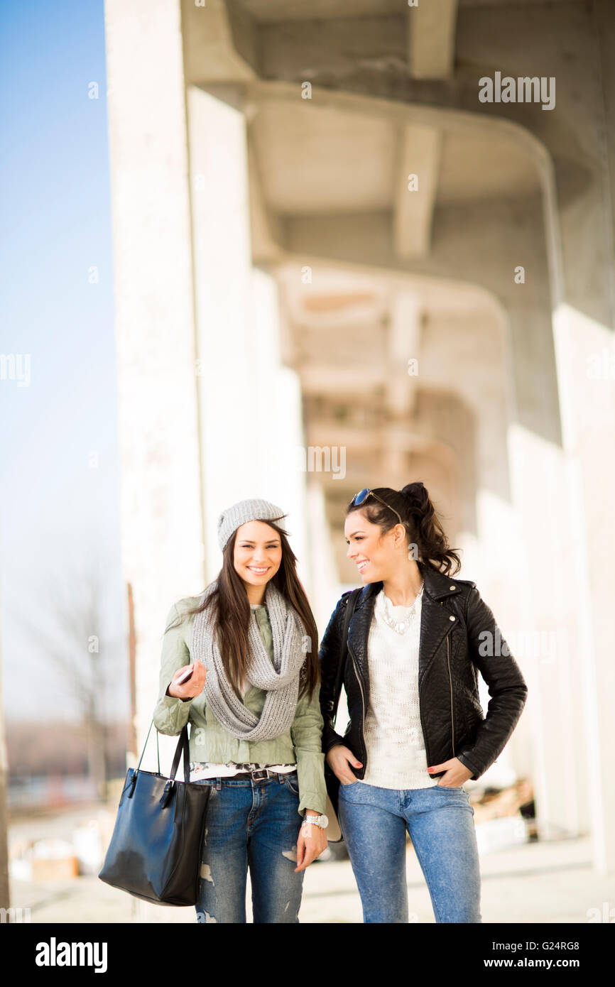 Two women walking together on the street Stock Photo - Alamy