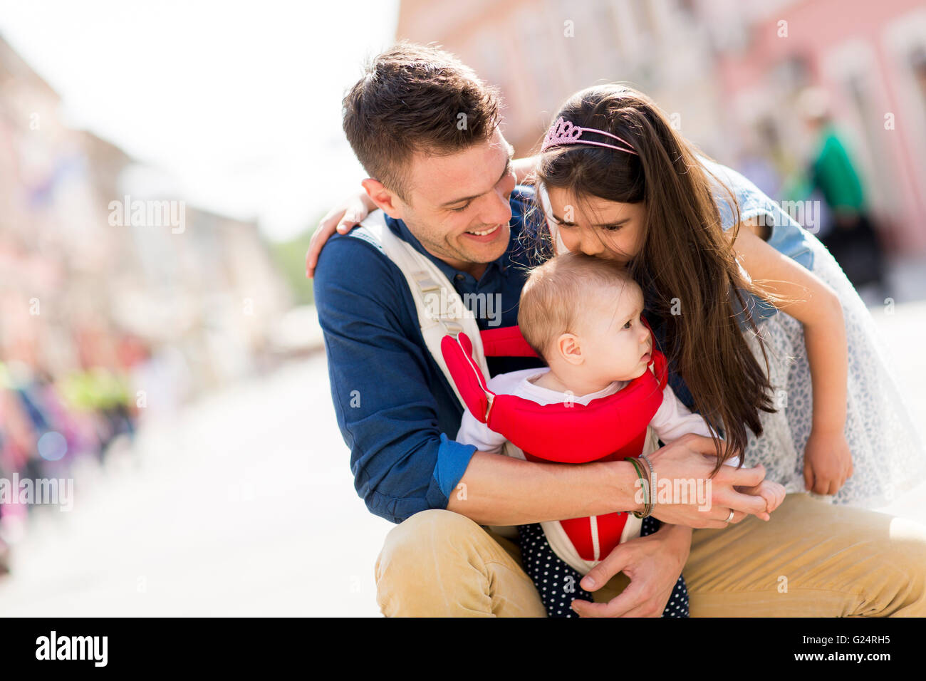 Father with a daughter and a baby walking on the street Stock Photo - Alamy