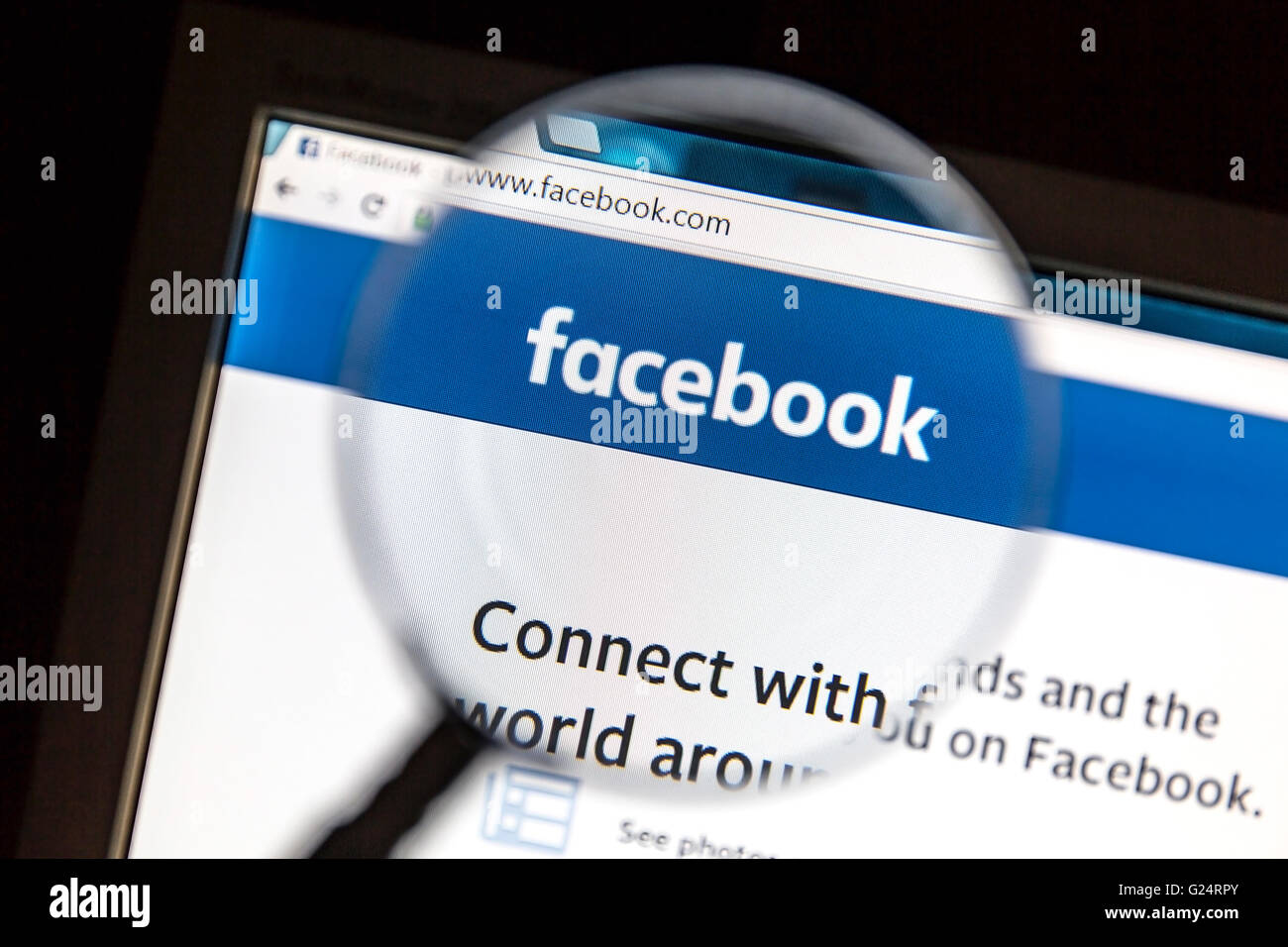 Facebook website under a magnifying glass. Facebook is the most visited ...