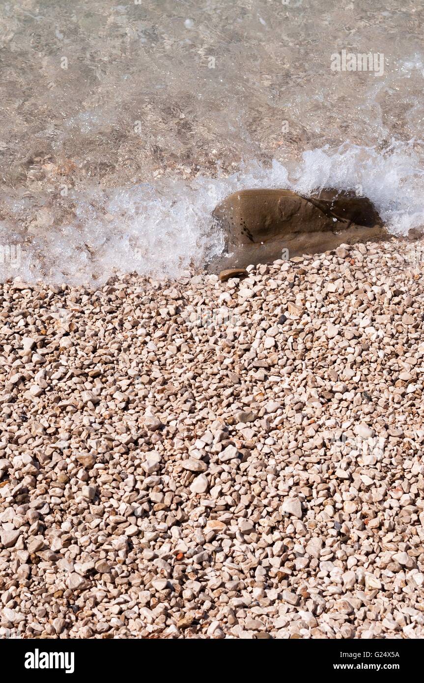 Stones on the beach with wave. Podgora, Croatia. Vertical photo Stock ...