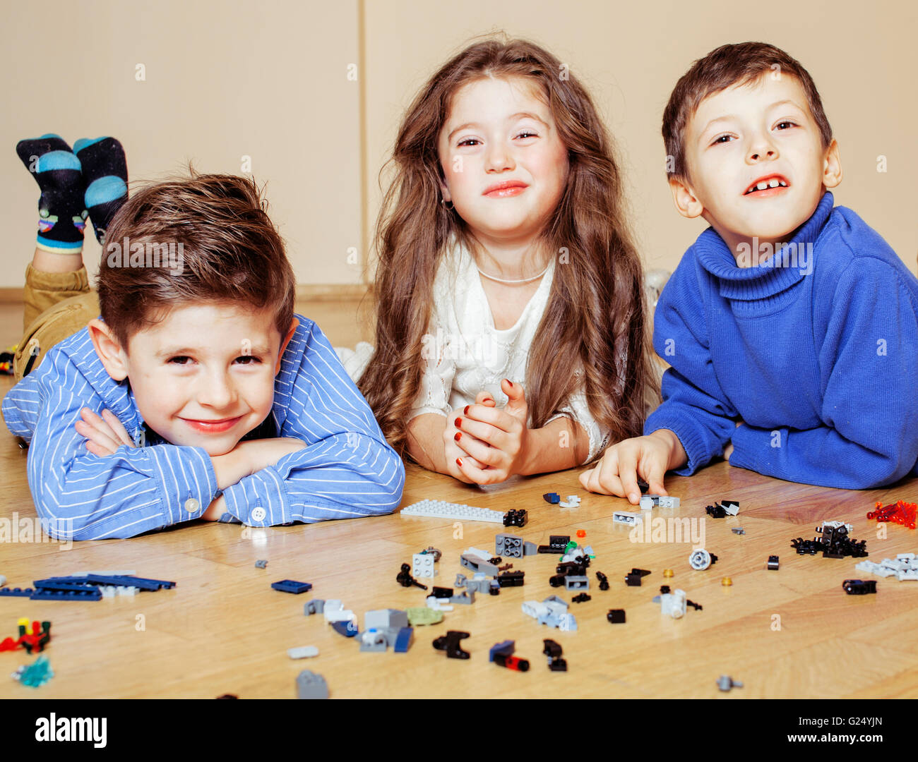 funny cute children playing lego at home, boys and girl smiling, first ...