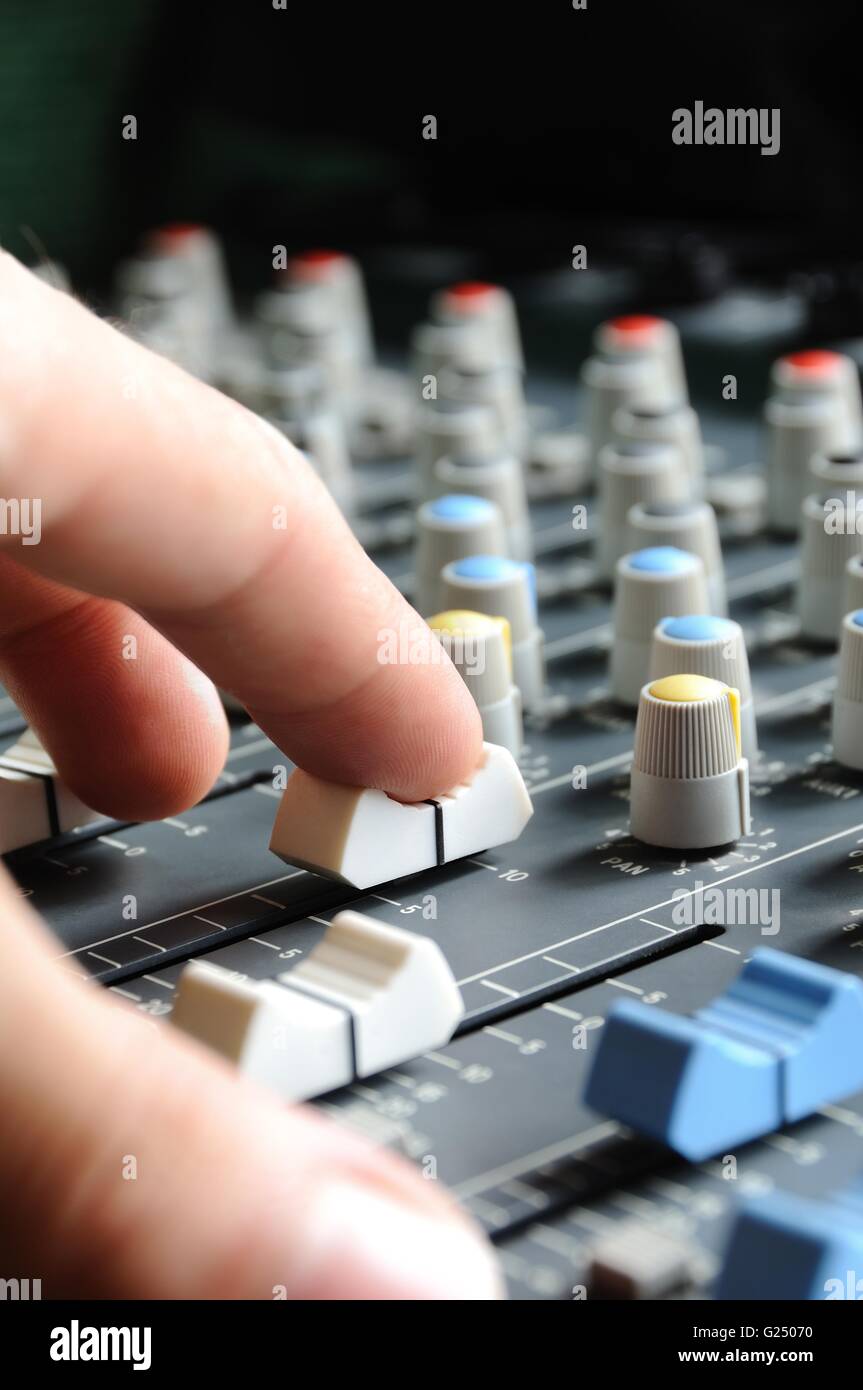 Man adjusting audio mixer Stock Photo - Alamy