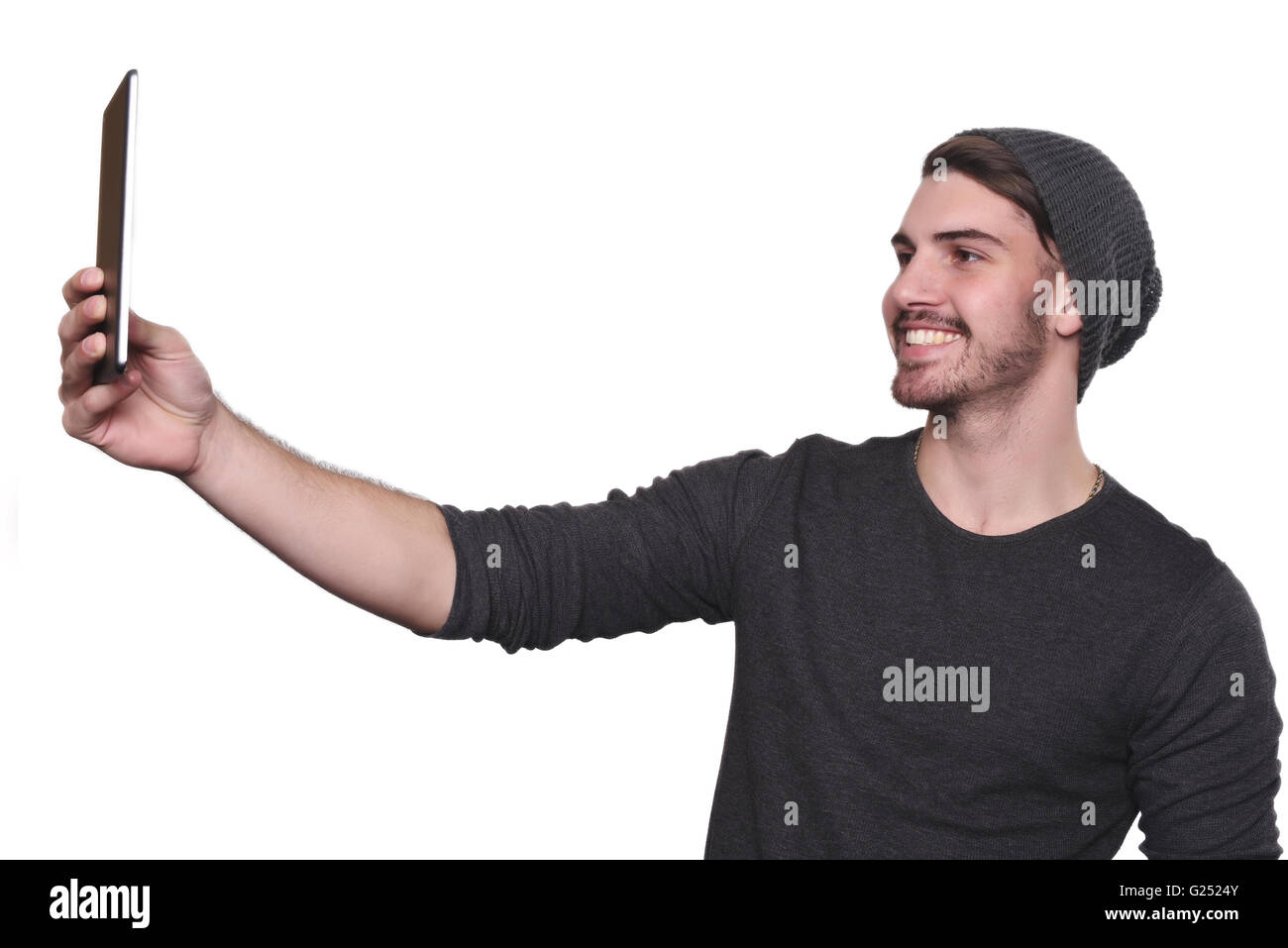 Portrait of attractive young man taking selfie with tablet. Isolated ...