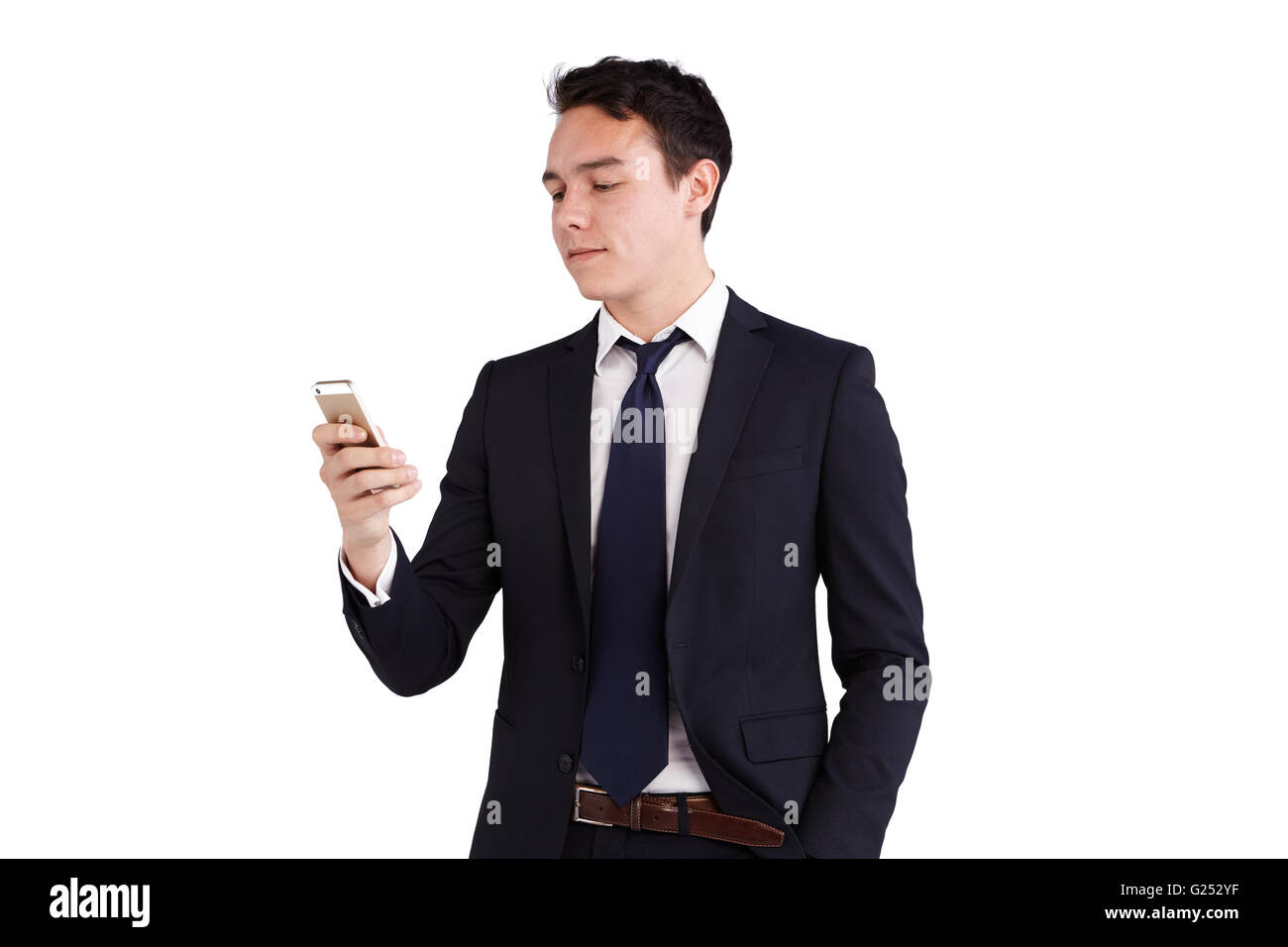 A young Caucasian business man is looking and holding his mobile phone ...
