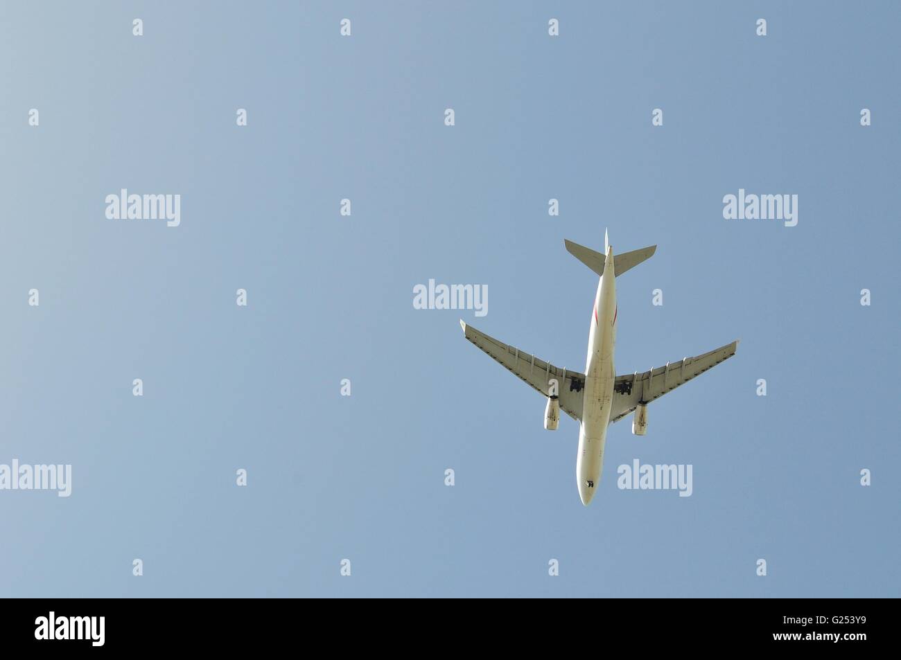Large passenger airplane flying in the blue sky. Space in left side ...