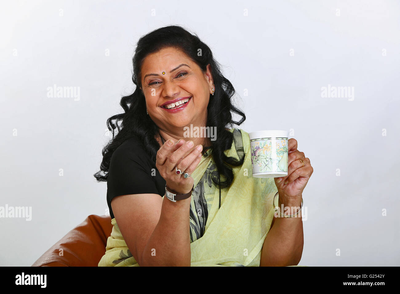 Happy woman drinking tea Stock Photo - Alamy