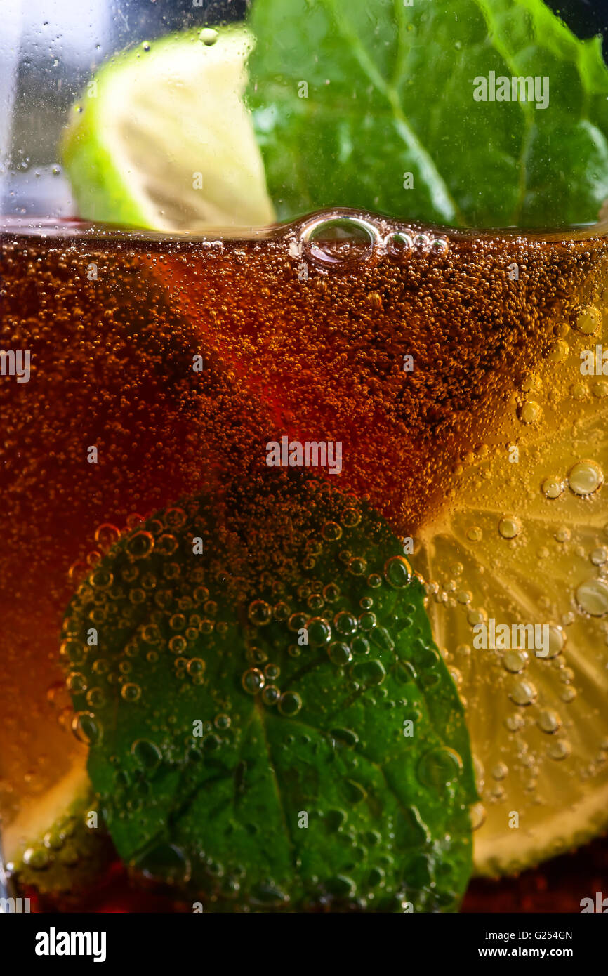 cola with lime , ice and peppermint leaves Stock Photo - Alamy