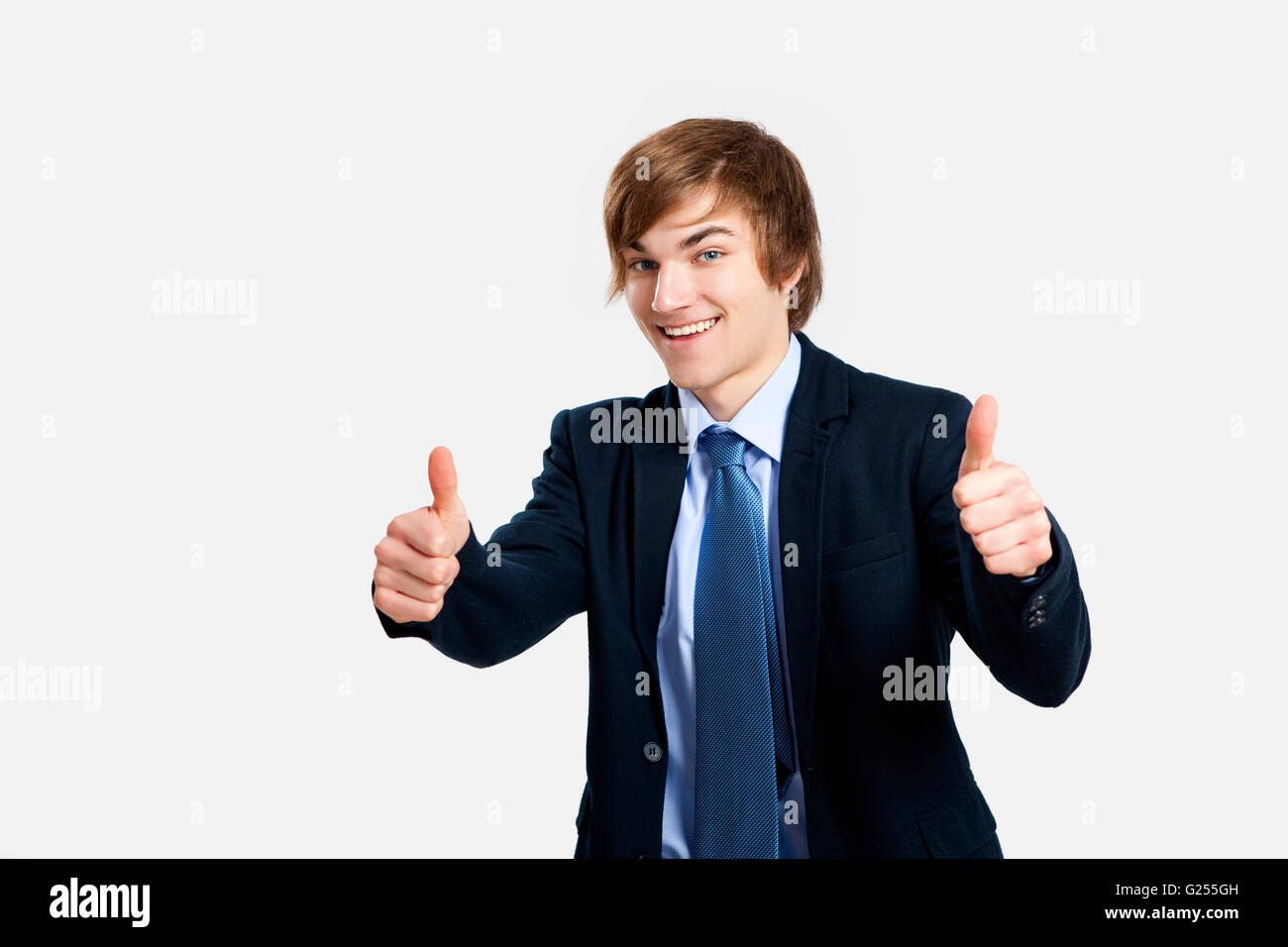 Young businessman with thumbs up, over a gray background Stock Photo ...