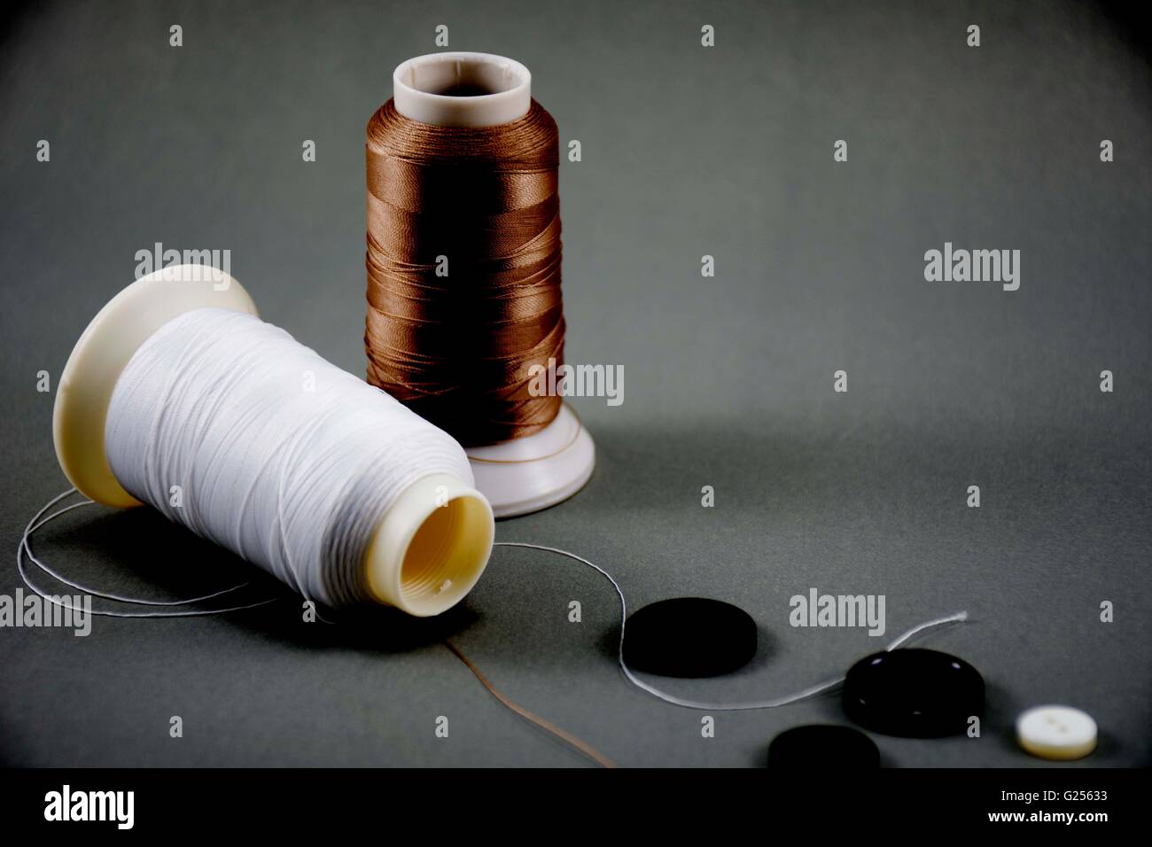 Brown thread with white thread.And buttons black and white.On black ...