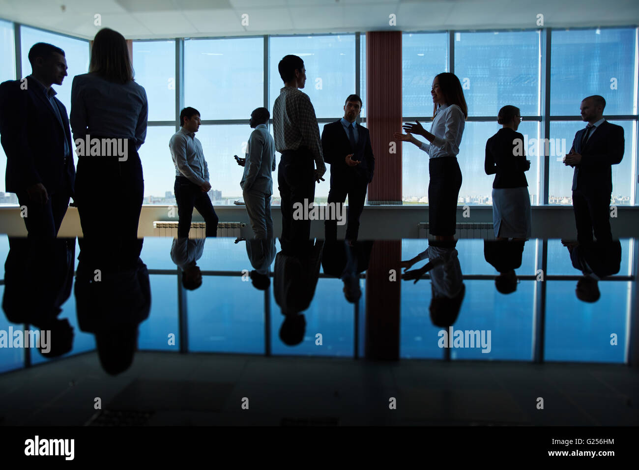 Talking by window Stock Photo - Alamy