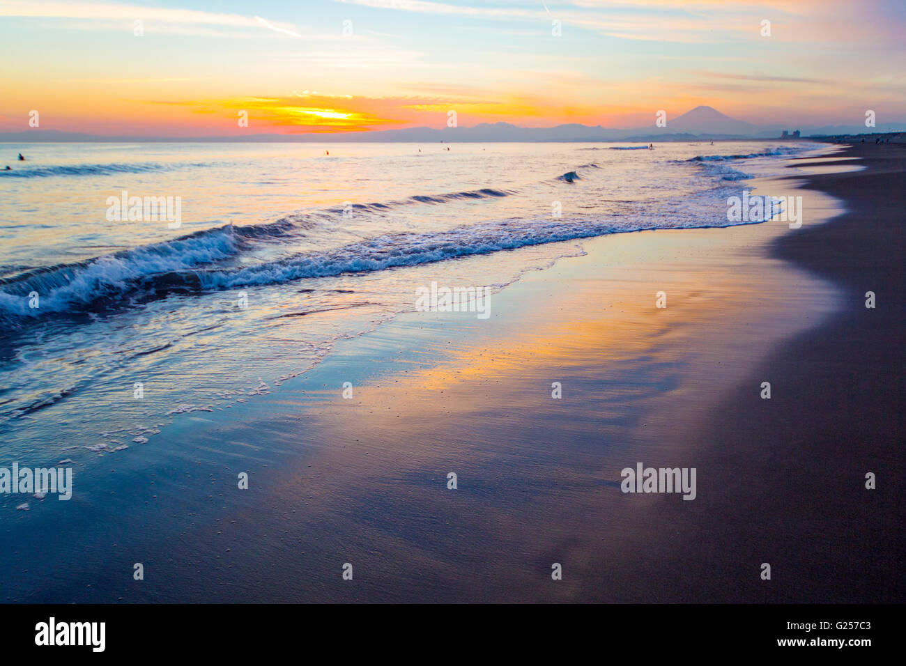 Wave on the beach at sunset Stock Photo - Alamy