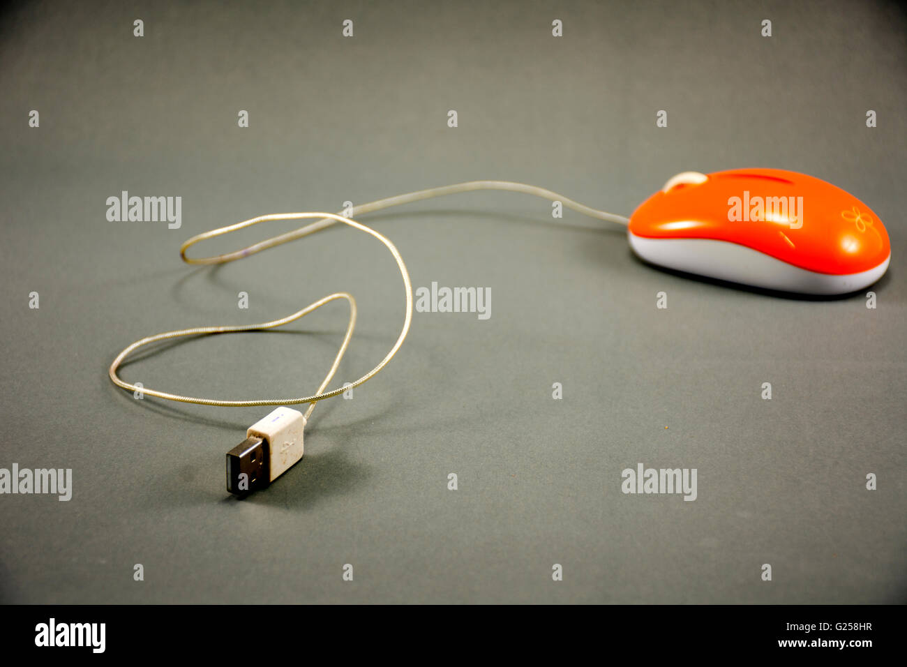 Optical mouse,orange,On gray background Stock Photo - Alamy