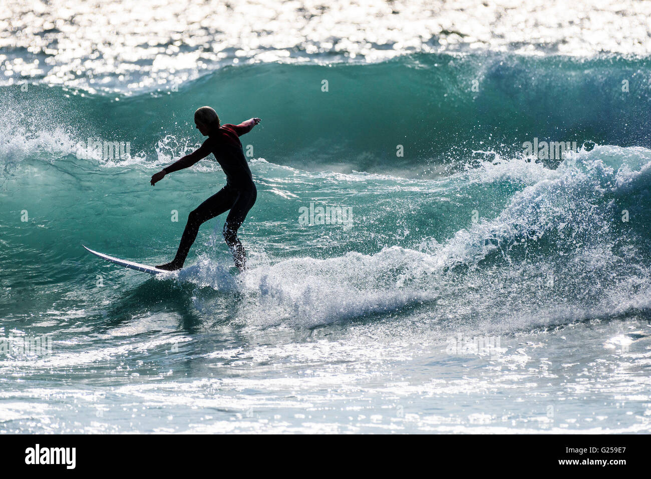 A surfer in spectacular action at Fistral in Newquay, Cornwall, England ...