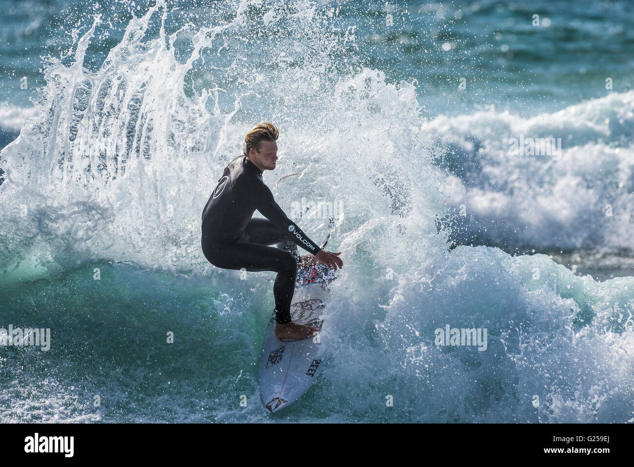 A surfer in spectacular action at Fistral in Newquay, Cornwall, England ...
