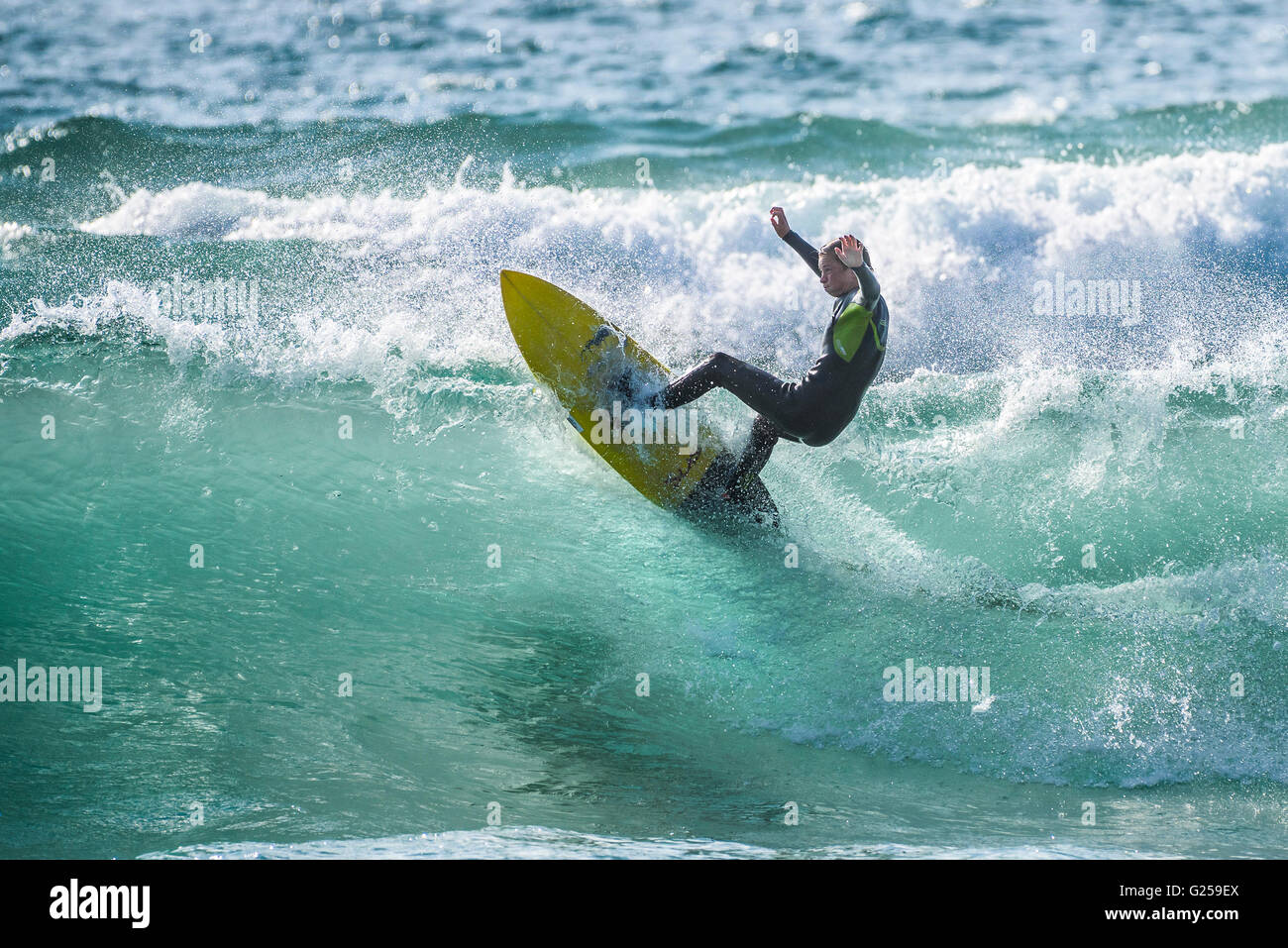 A surfer in spectacular action at Fistral in Newquay, Cornwall, England ...