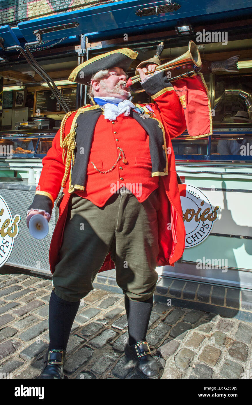 Town Crier blowing bugle trumpet, red livery and buckled shoes, red ...