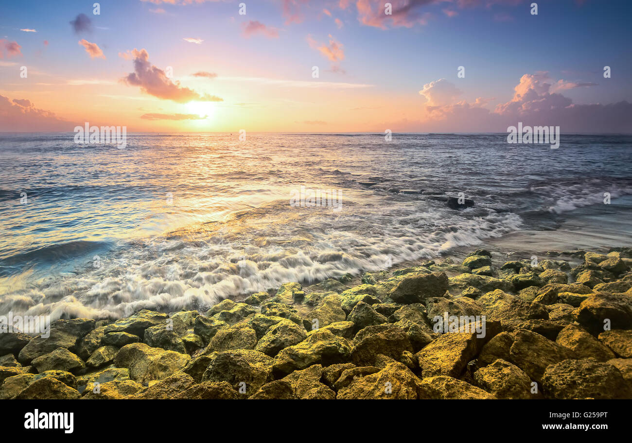 Sunset with rocks on beach hi-res stock photography and images - Alamy