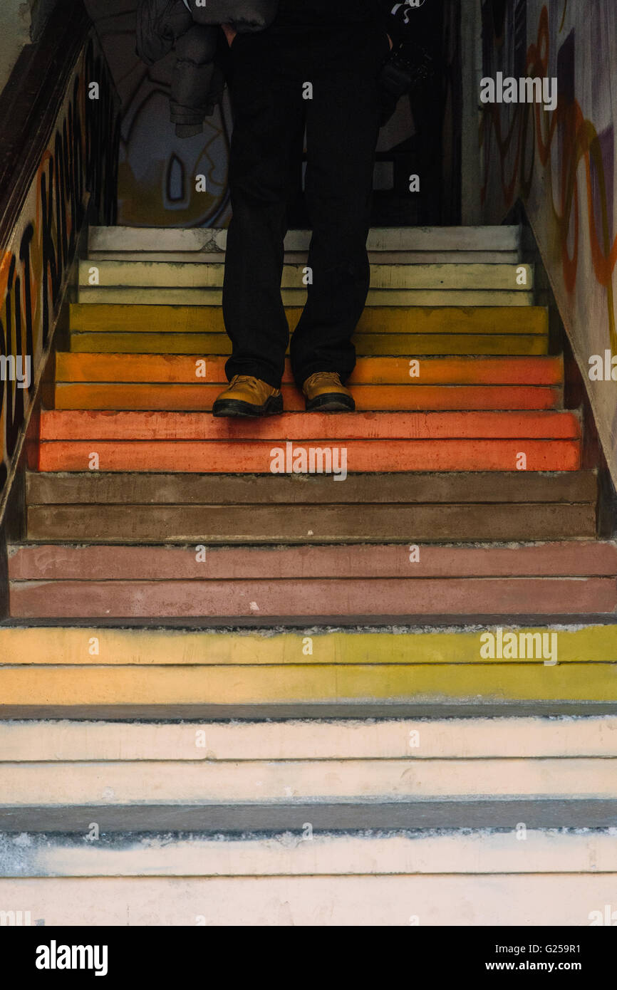 Boy walking down multi coloured steps Stock Photo - Alamy