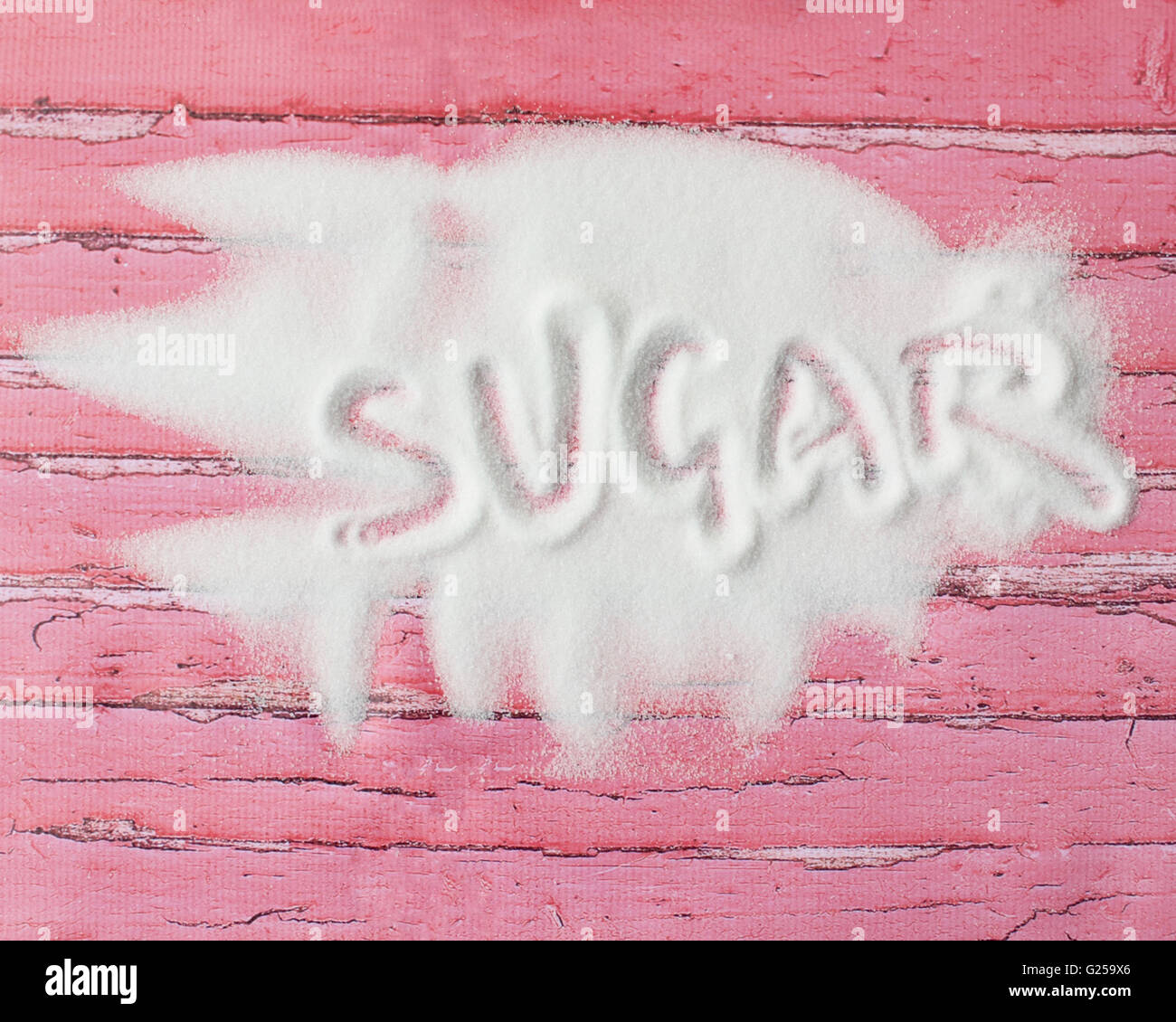 Word sugar written in sugar on pink wooden table Stock Photo - Alamy