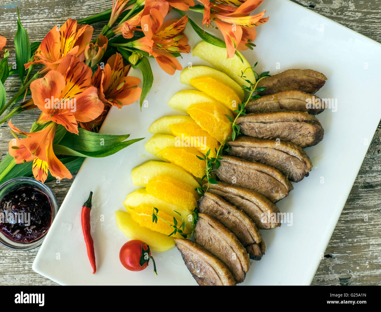 Slices of roasted duck with orange and pear slices Stock Photo - Alamy