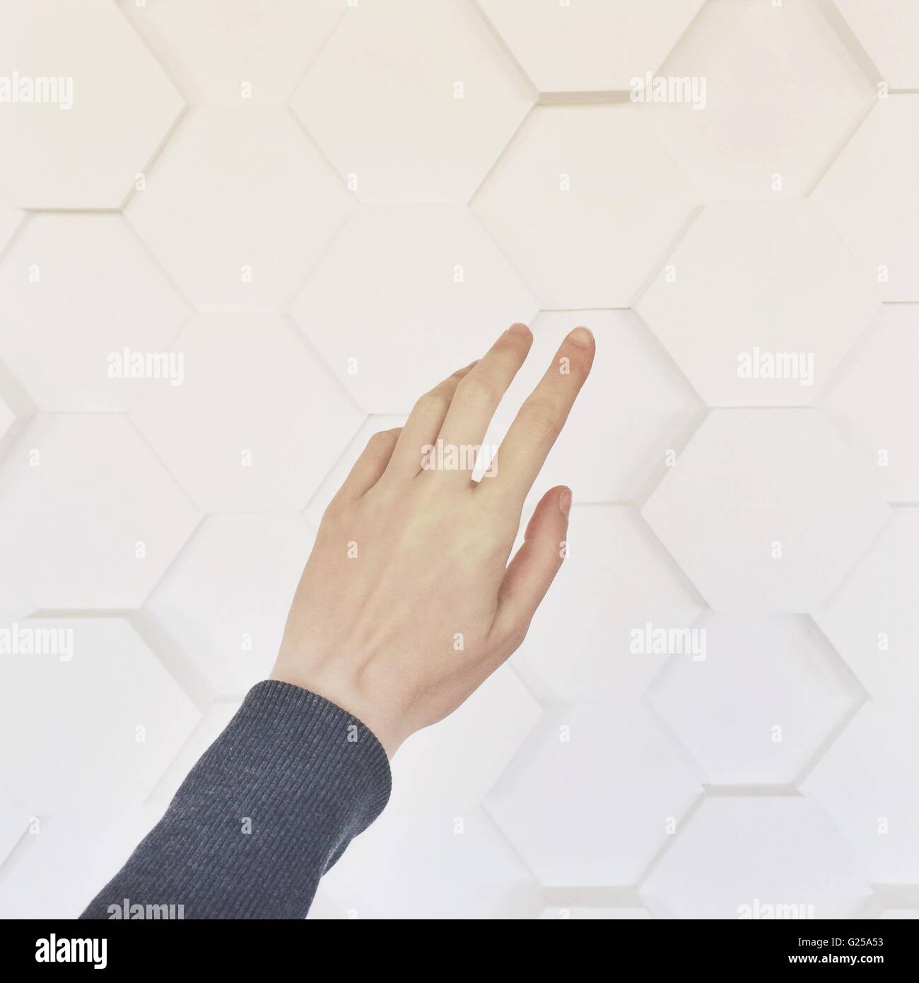 Outstretched hand reaching for white wall Stock Photo - Alamy