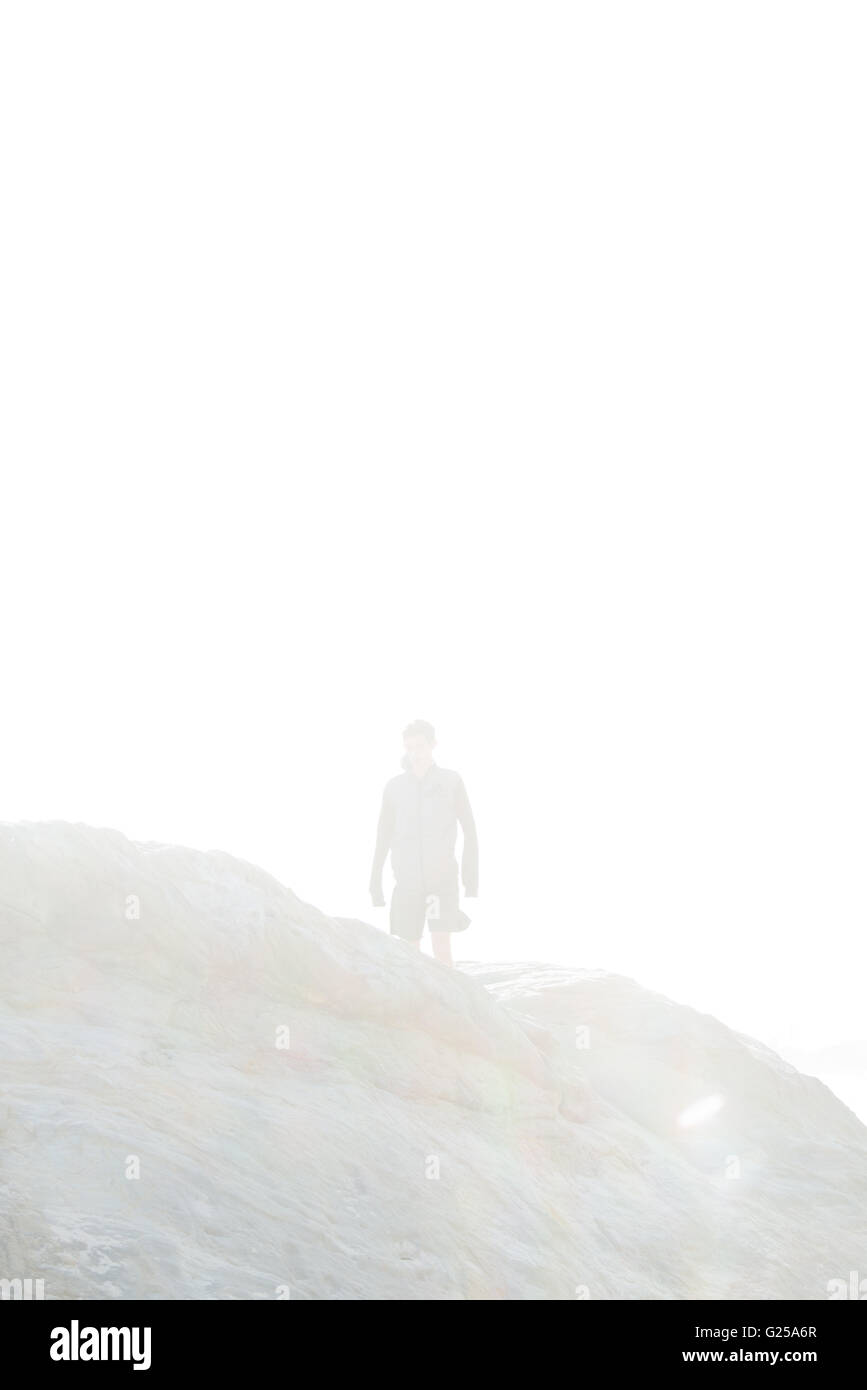Silhouette of a man standing on beach in mist Stock Photo - Alamy