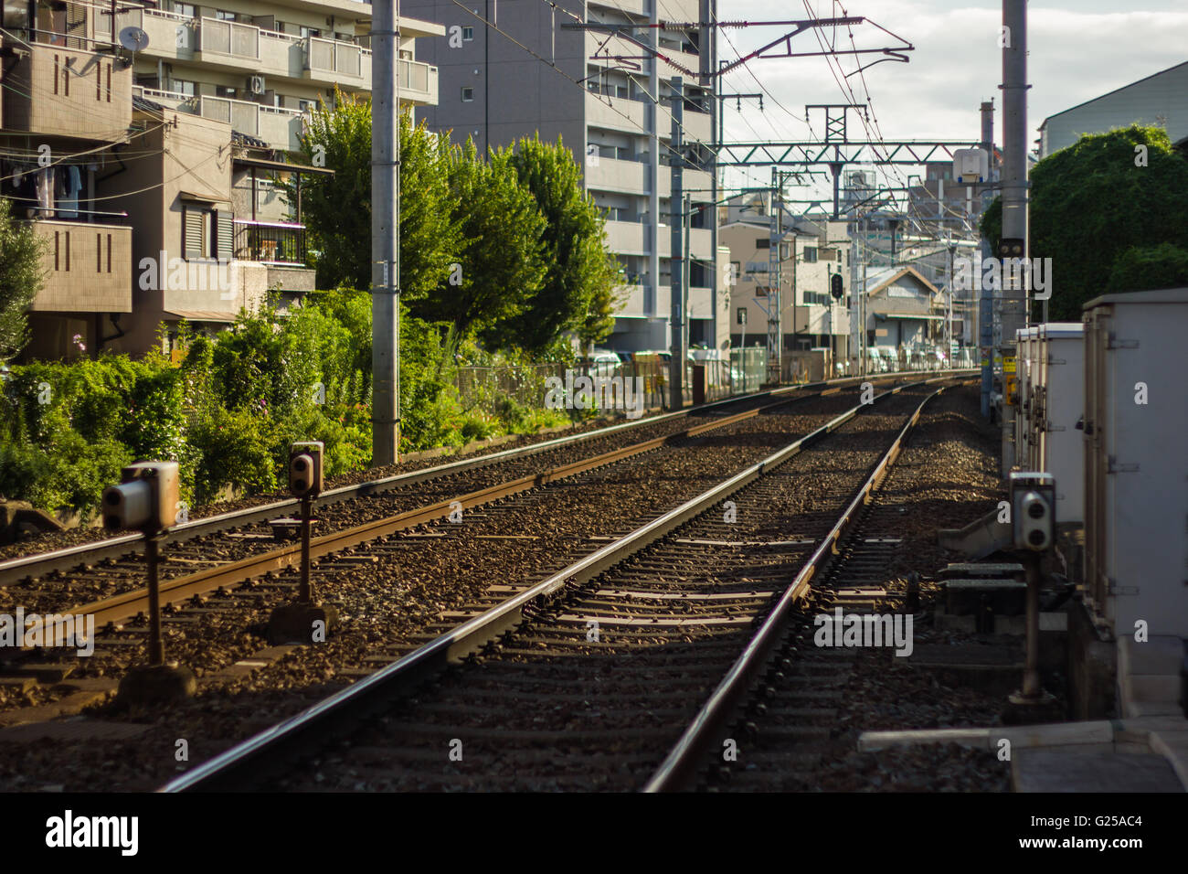 Railway tracks through city Stock Photo - Alamy