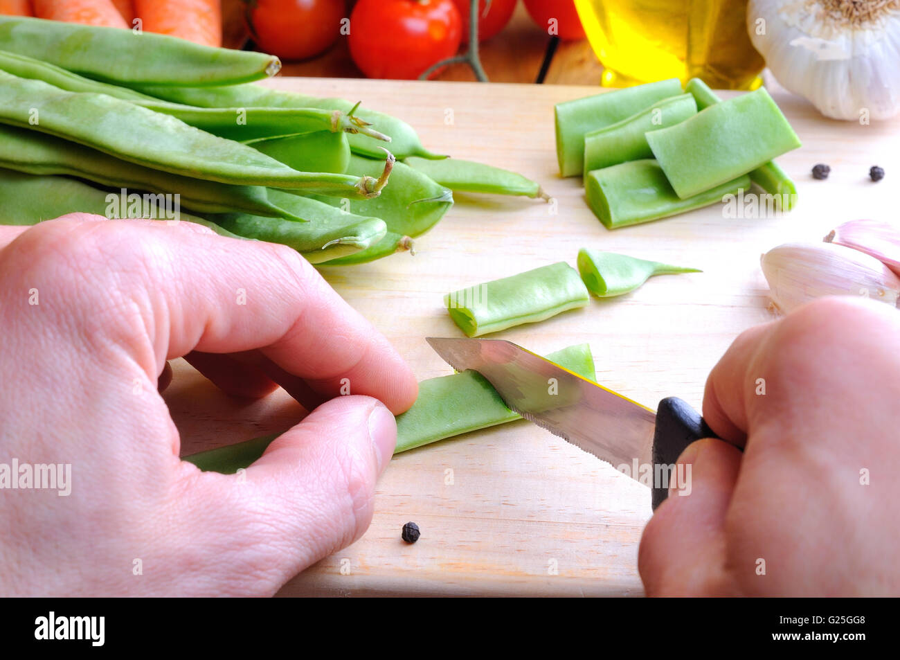 Cook cut green beans for cooking on a cutting board on a kitchen table ...