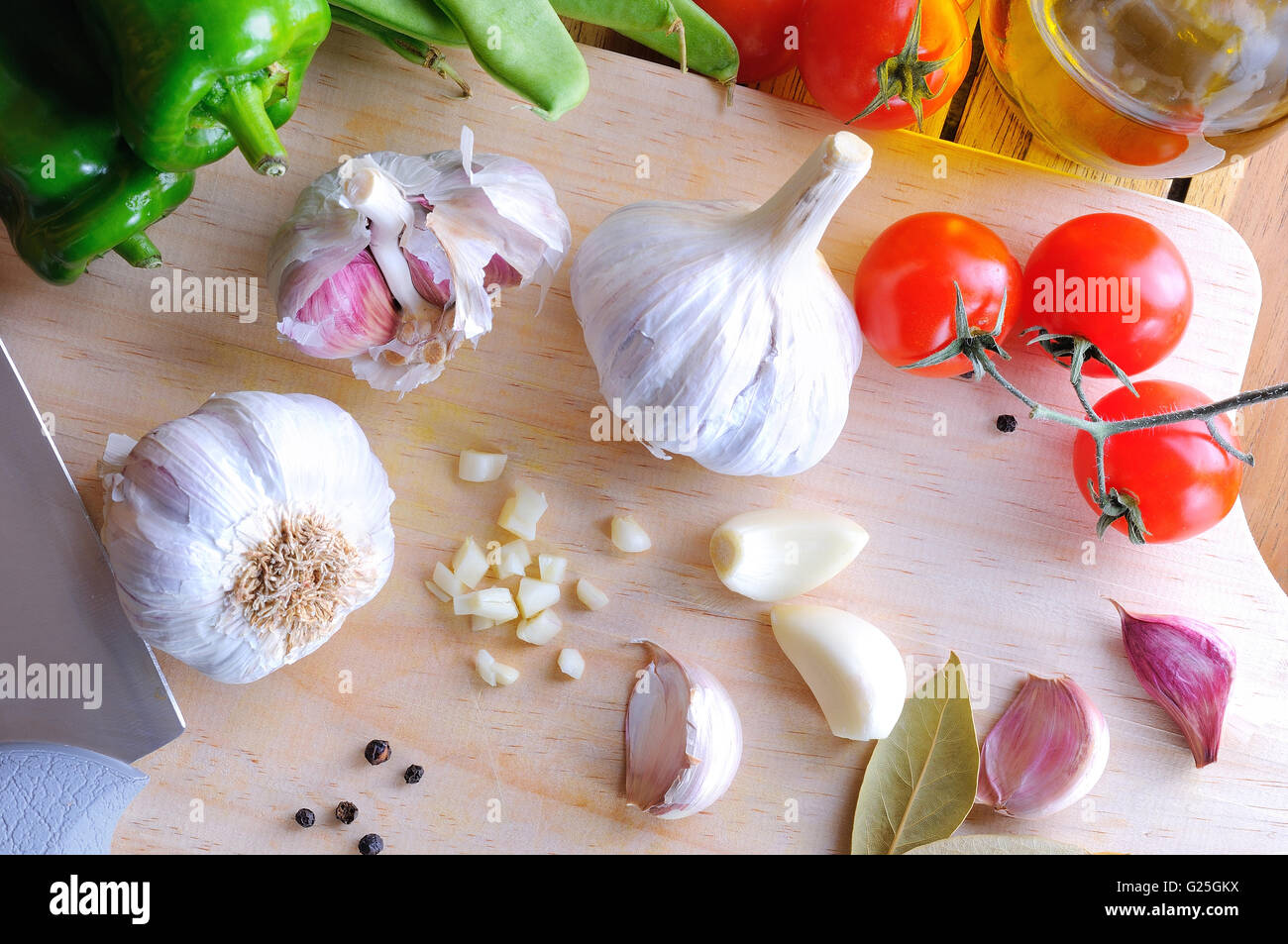 white garlic prepared on a cutting table for cooking with vegetables ...
