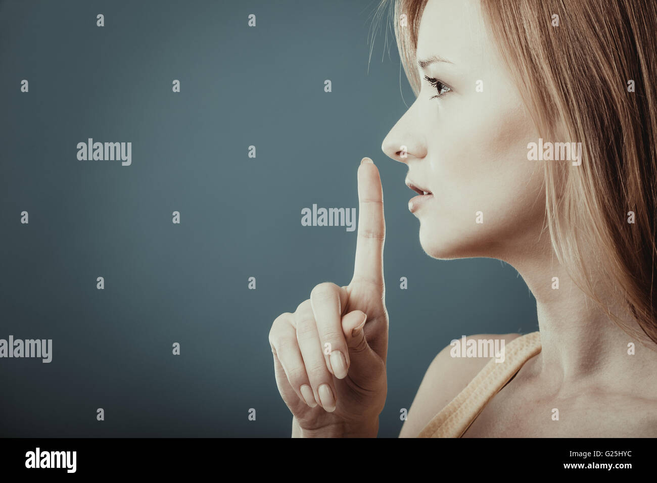 Closeup woman asking for silence or secrecy with finger on lips hush ...