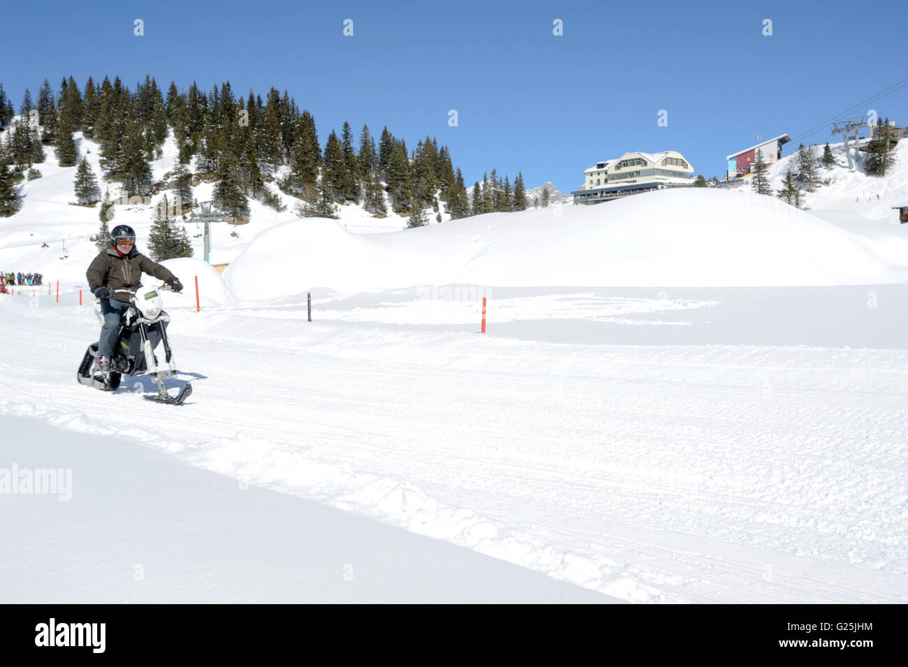 Engelberg, Switzerland - 7 March 2014: Men on snowmobile at Engelberg ...
