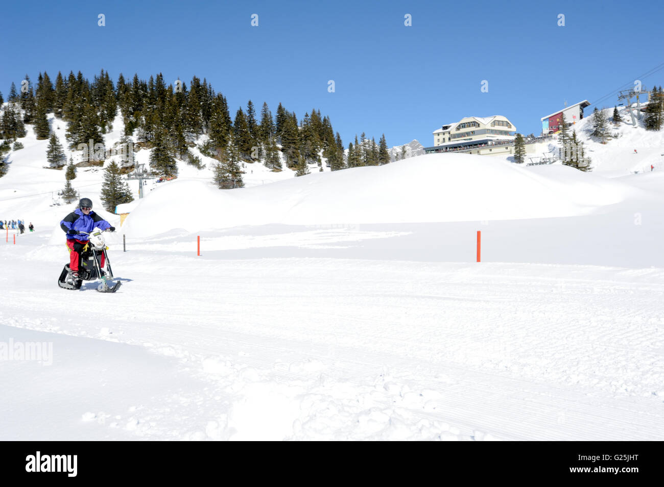 Engelberg, Switzerland - 7 March 2014: Men on snowmobile at Engelberg ...
