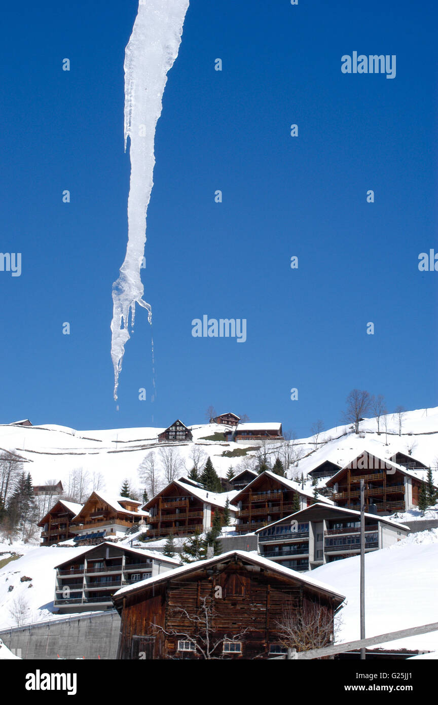 Winter background with icicle and houses Stock Photo - Alamy