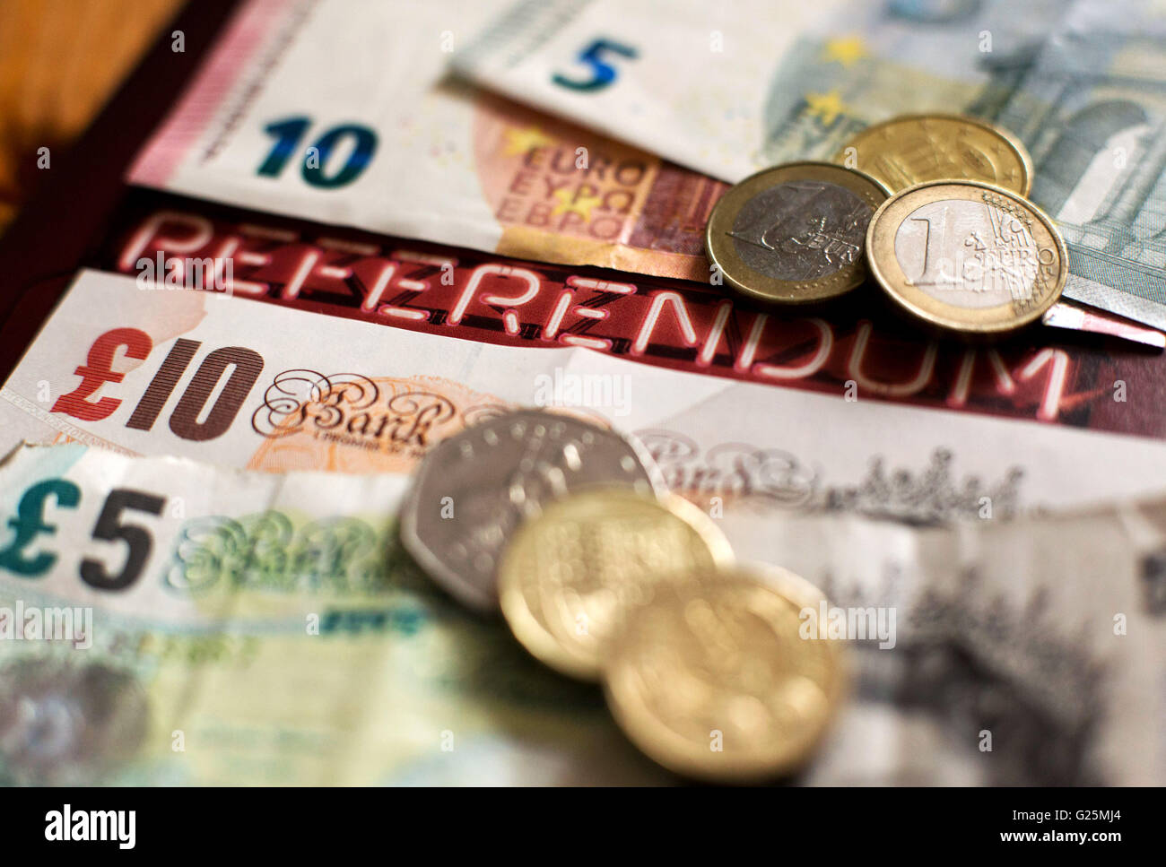 A euro coin and notes and a One Pound coin and UK banknotes, in London ...