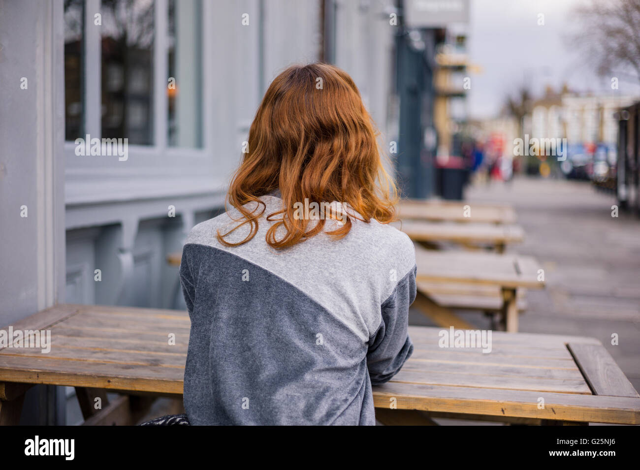 Woman sitting outside of pub hi-res stock photography and images - Alamy