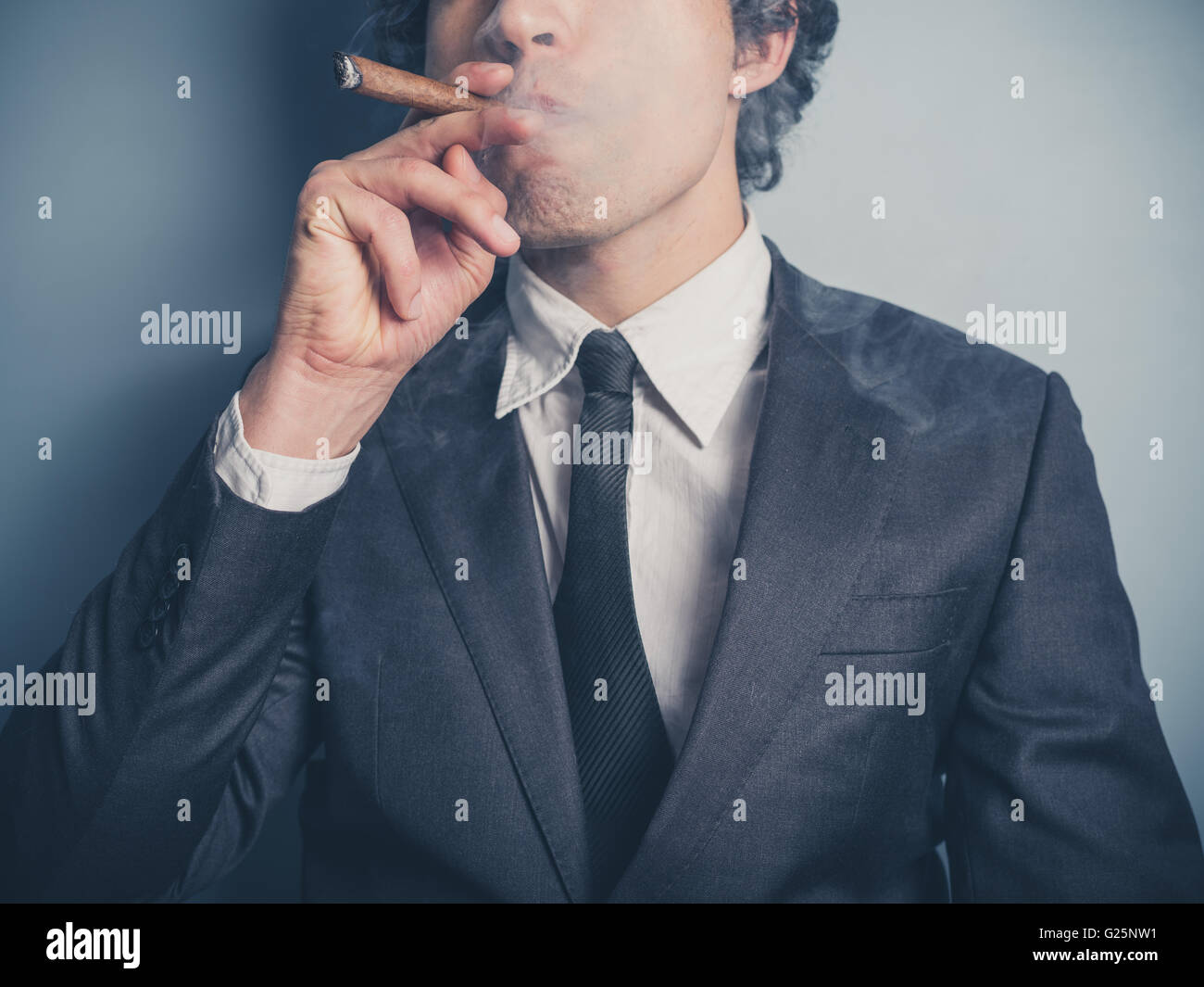 Businessman smoking cigar hi-res stock photography and images - Alamy