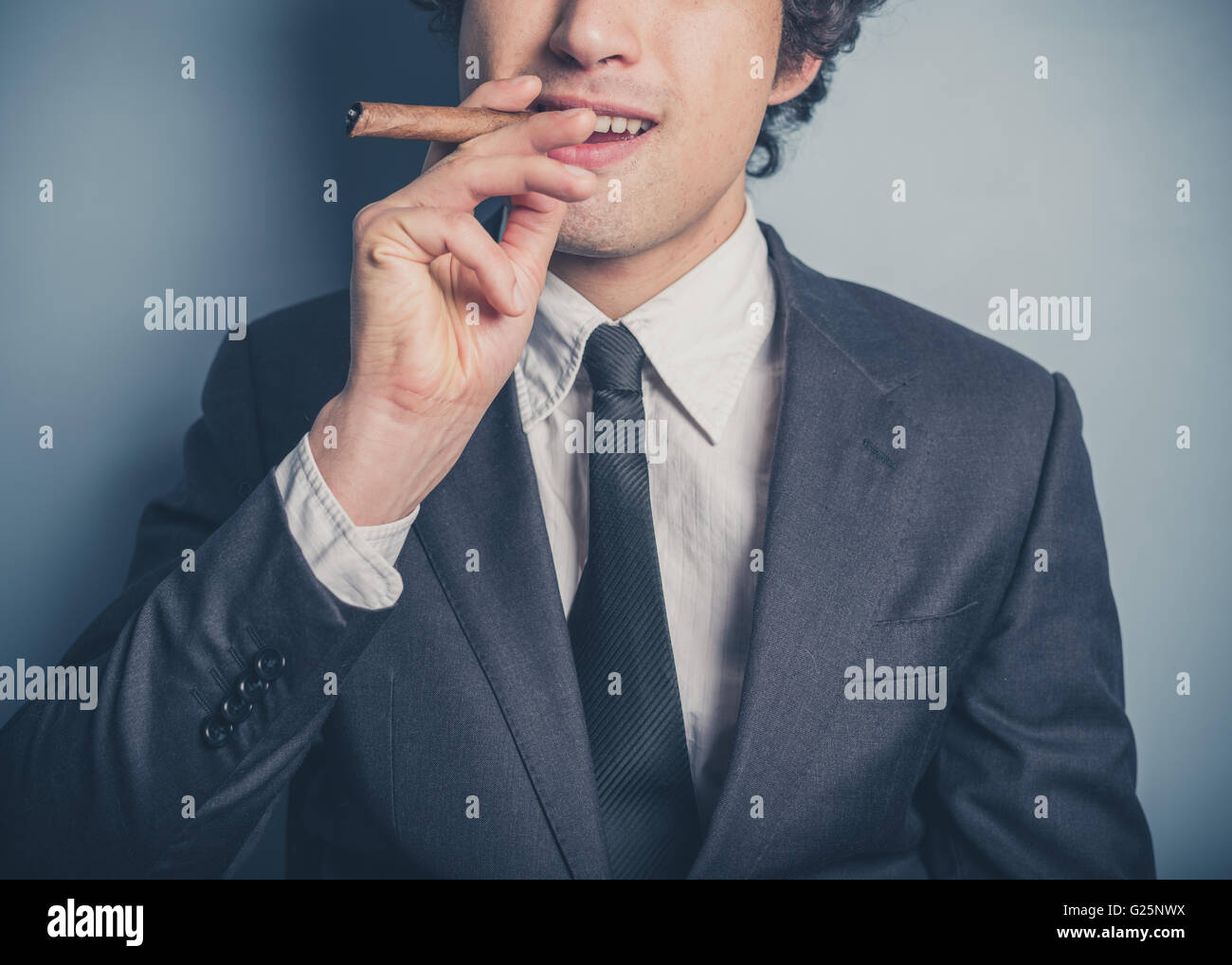 Businessman smoking cigar hi-res stock photography and images - Alamy