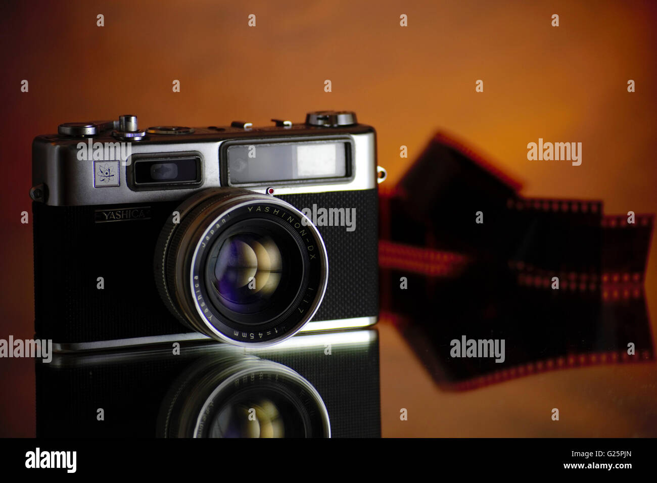 Film camera whit film in red background Stock Photo - Alamy