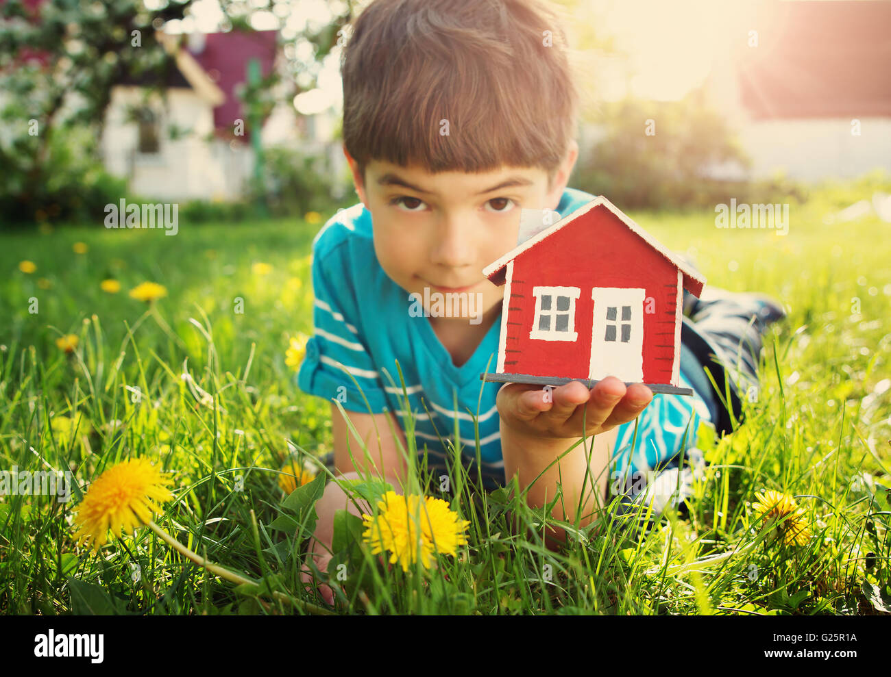 child holding red model house Stock Photo - Alamy