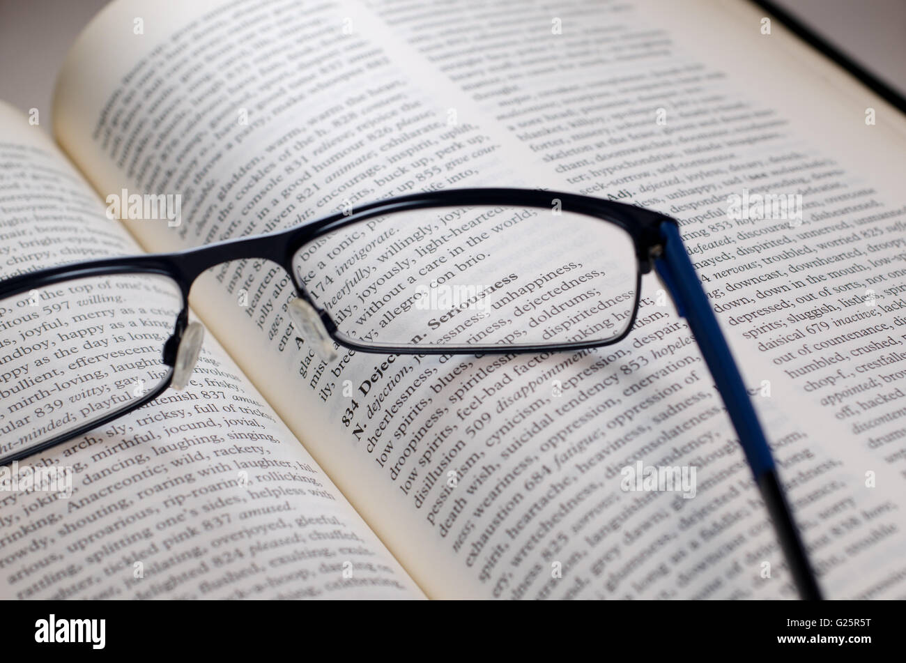 Glasses on book highlighting the word seriousness Stock Photo - Alamy