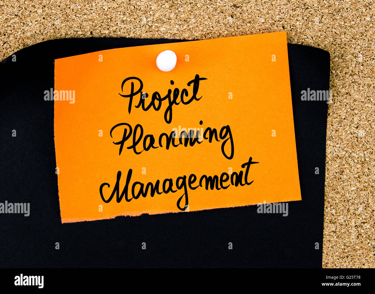 Project Planning Management written on orange paper note pinned on cork ...