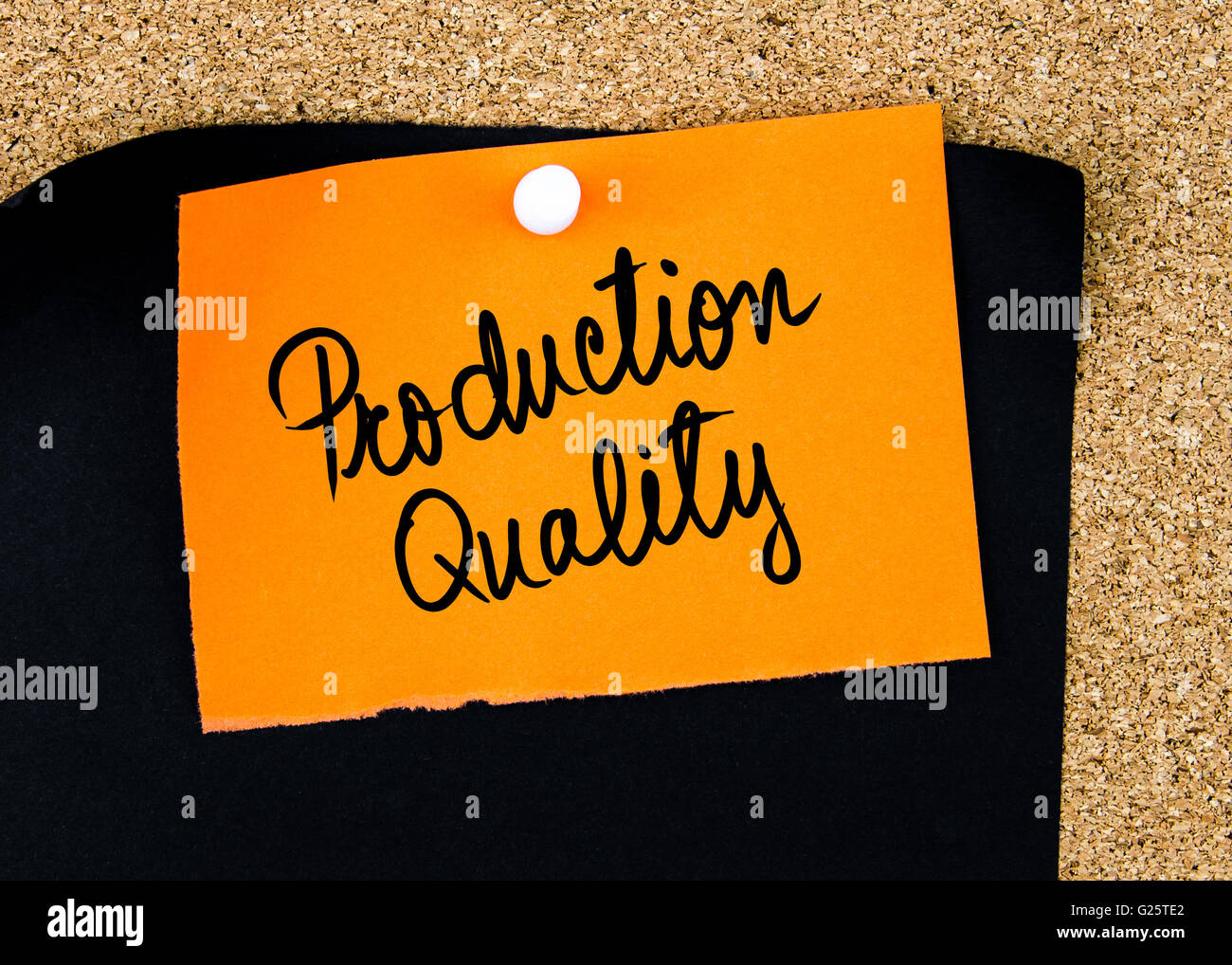 Production Quality written on orange paper note pinned on cork board ...