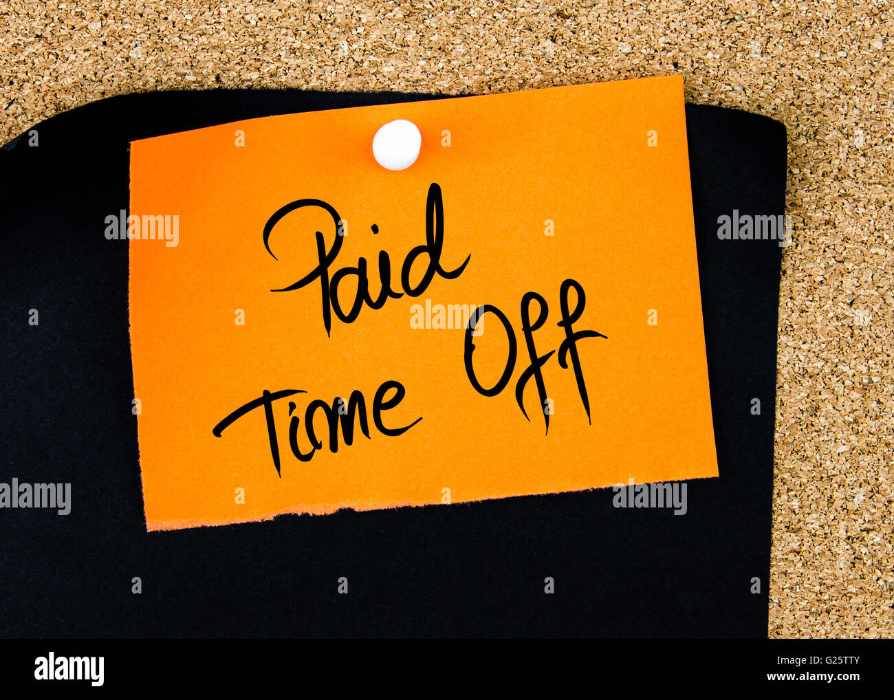Paid Time Off written on orange paper note pinned on cork board with ...
