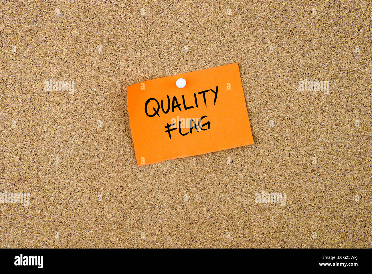 QUALITY FLAG written on orange paper note pinned on cork board with ...